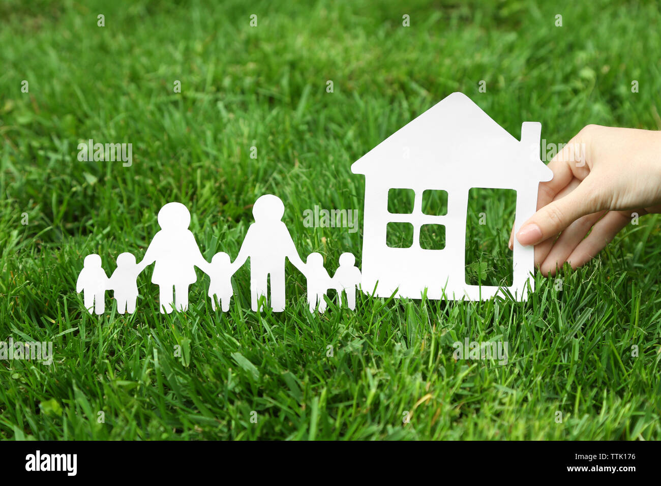 Woman hand holding wooden family shape. Love and relationships concept ...