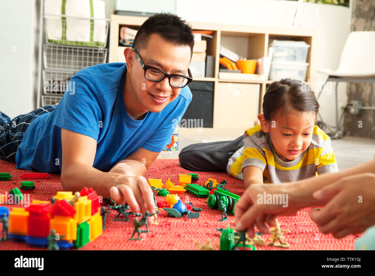 Father and children playing with toys on floor at home Stock Photo - Alamy