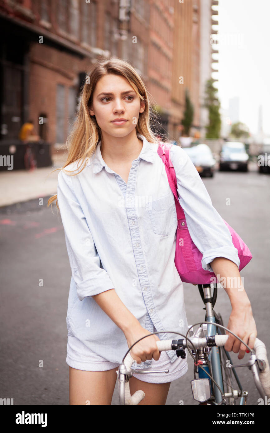 Woman walking bicycle in hi-res stock photography and images - Alamy