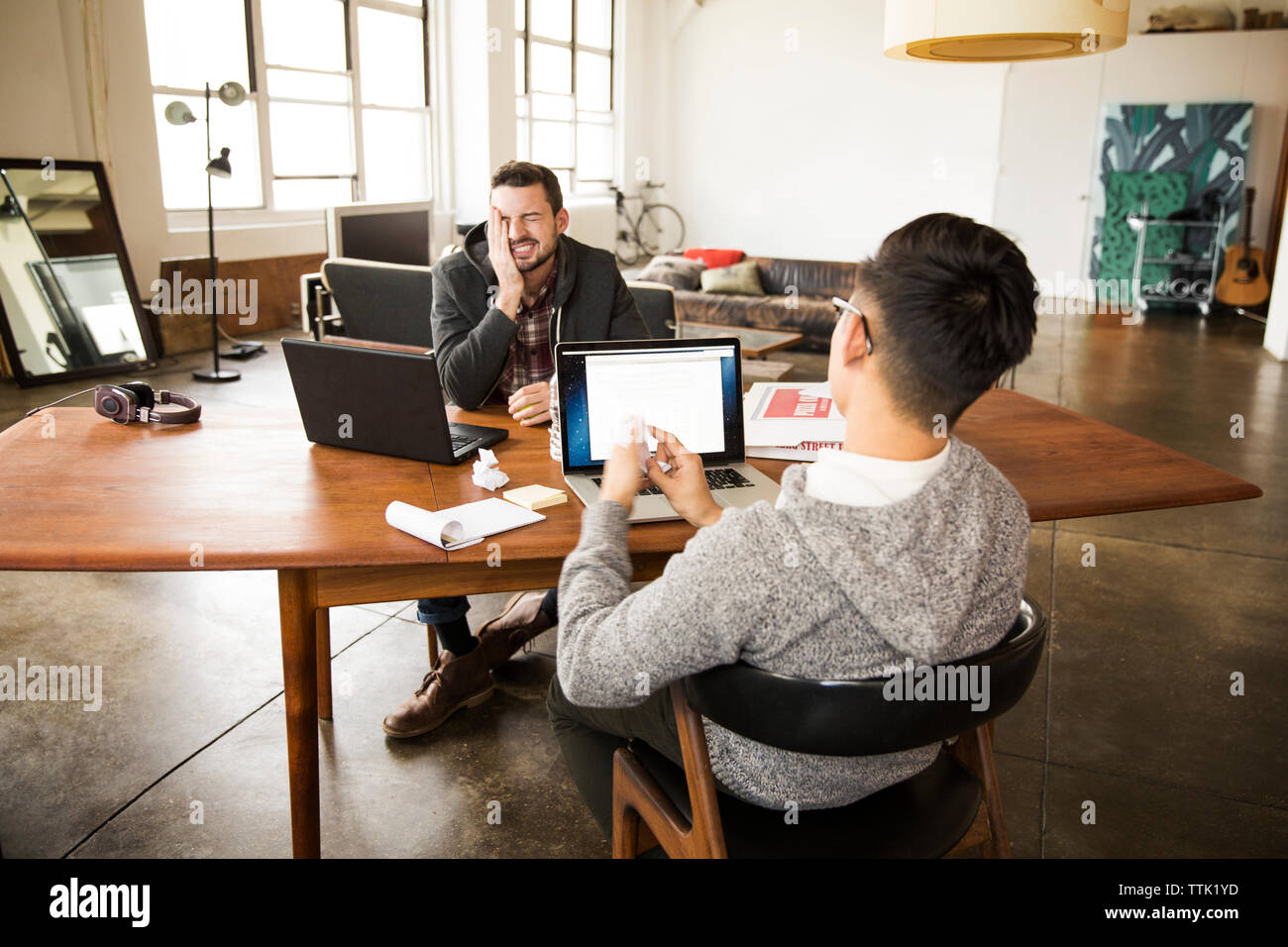 Colleagues in office using laptops hi-res stock photography and images ...