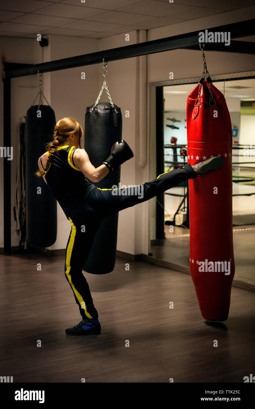 Athlete kick boxing while exercising in gym Stock Photo - Alamy