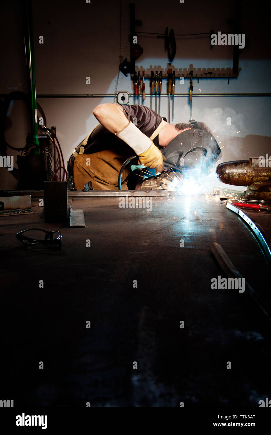 Male worker welding in factory Stock Photo - Alamy