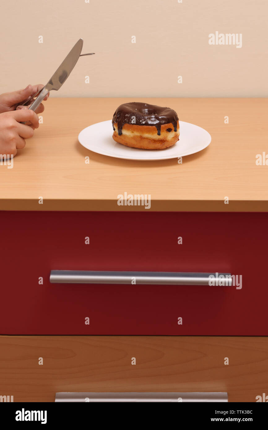 Indian person eating a donut Stock Photo - Alamy