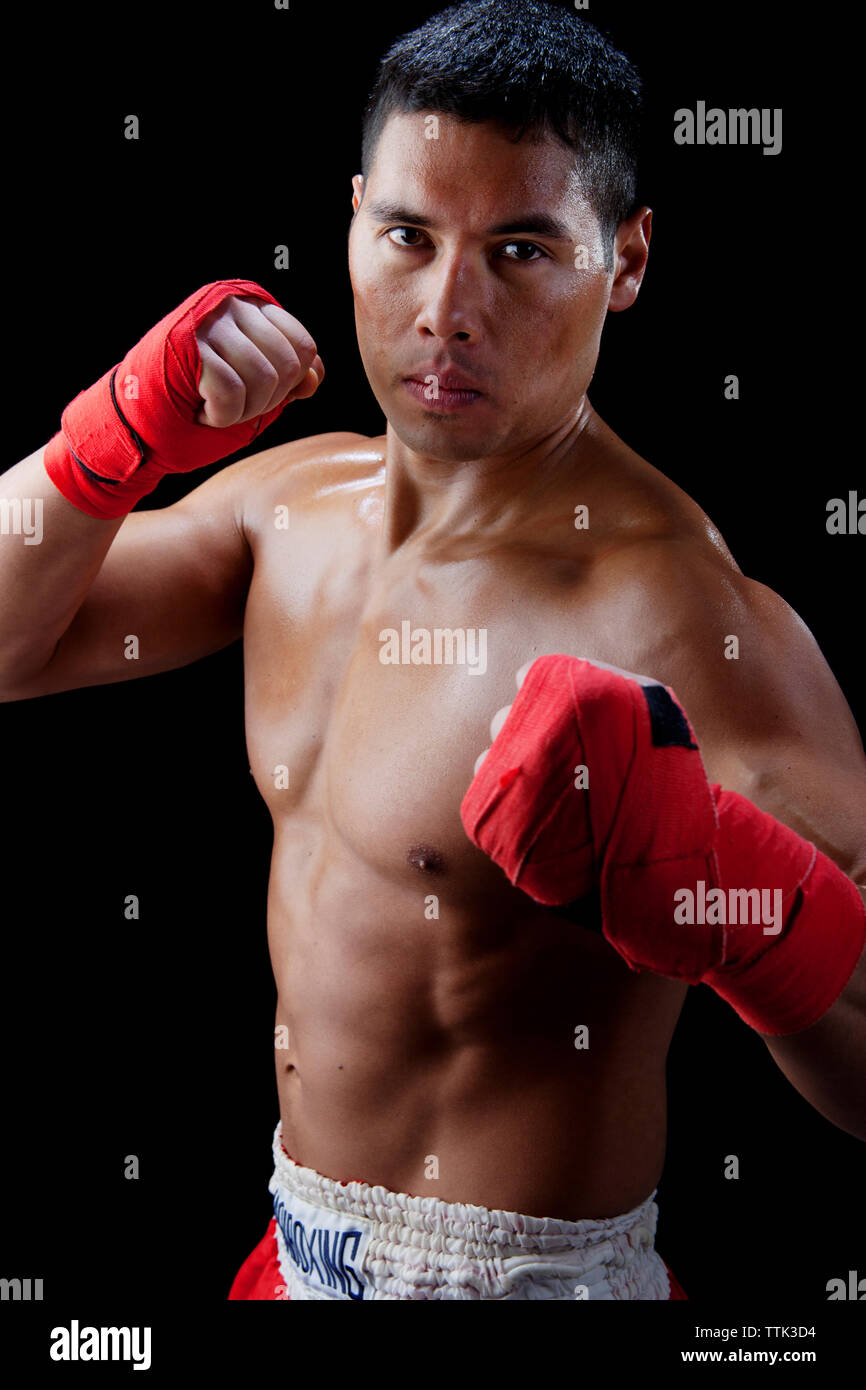 Portrait of shirtless confident boxer against black background Stock ...