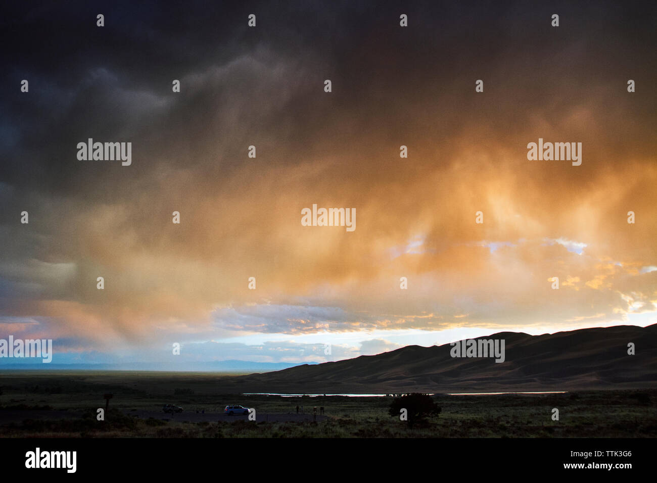 Cloudscape over land during sunset Stock Photo - Alamy