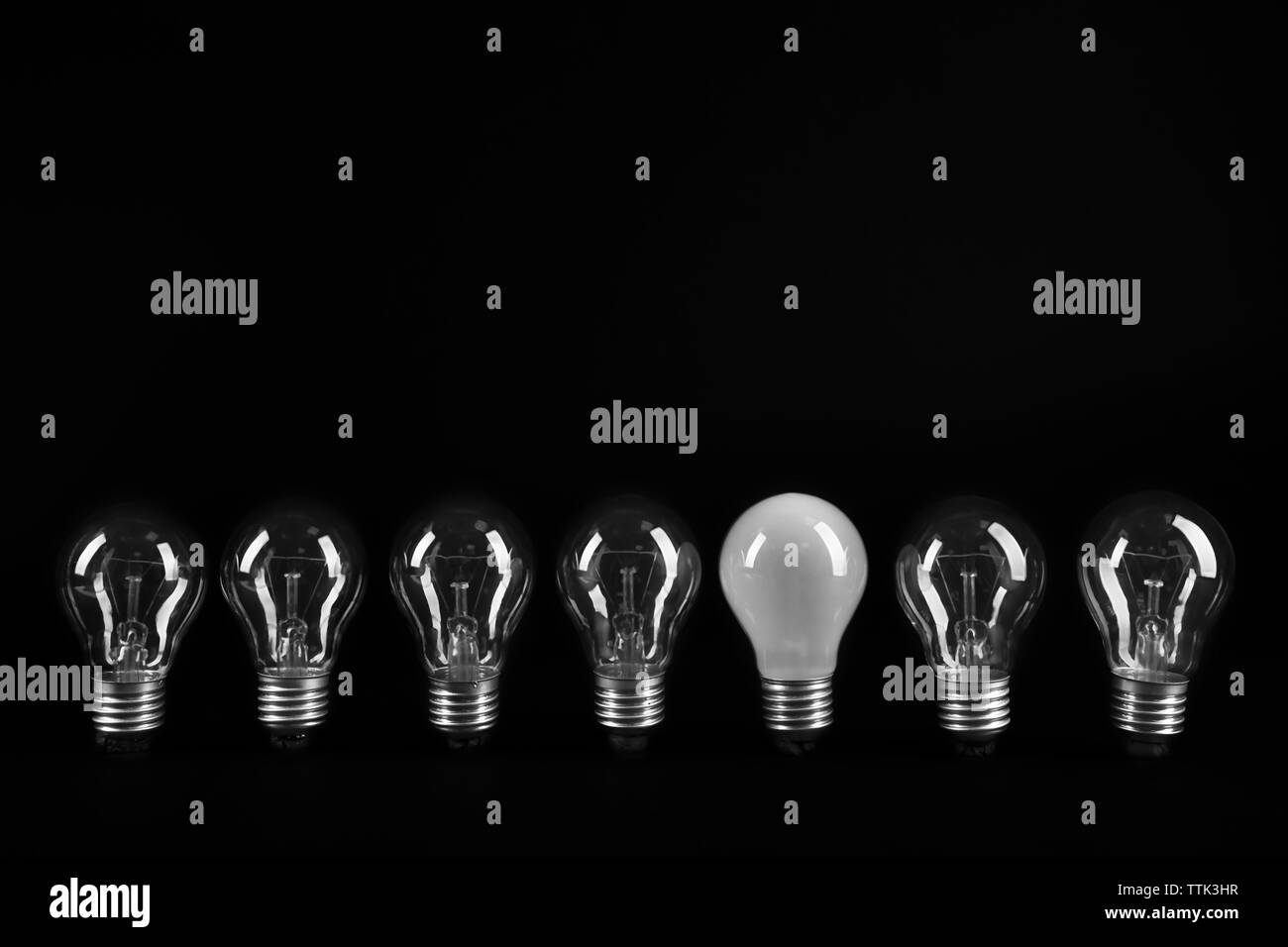 Electric bulbs on grey background Stock Photo - Alamy