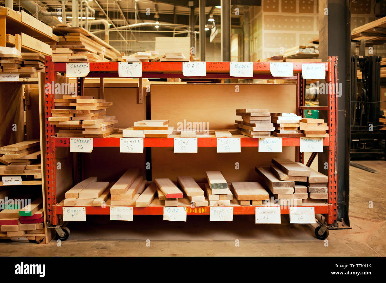 Wooden planks on shelves at workshop Stock Photo - Alamy