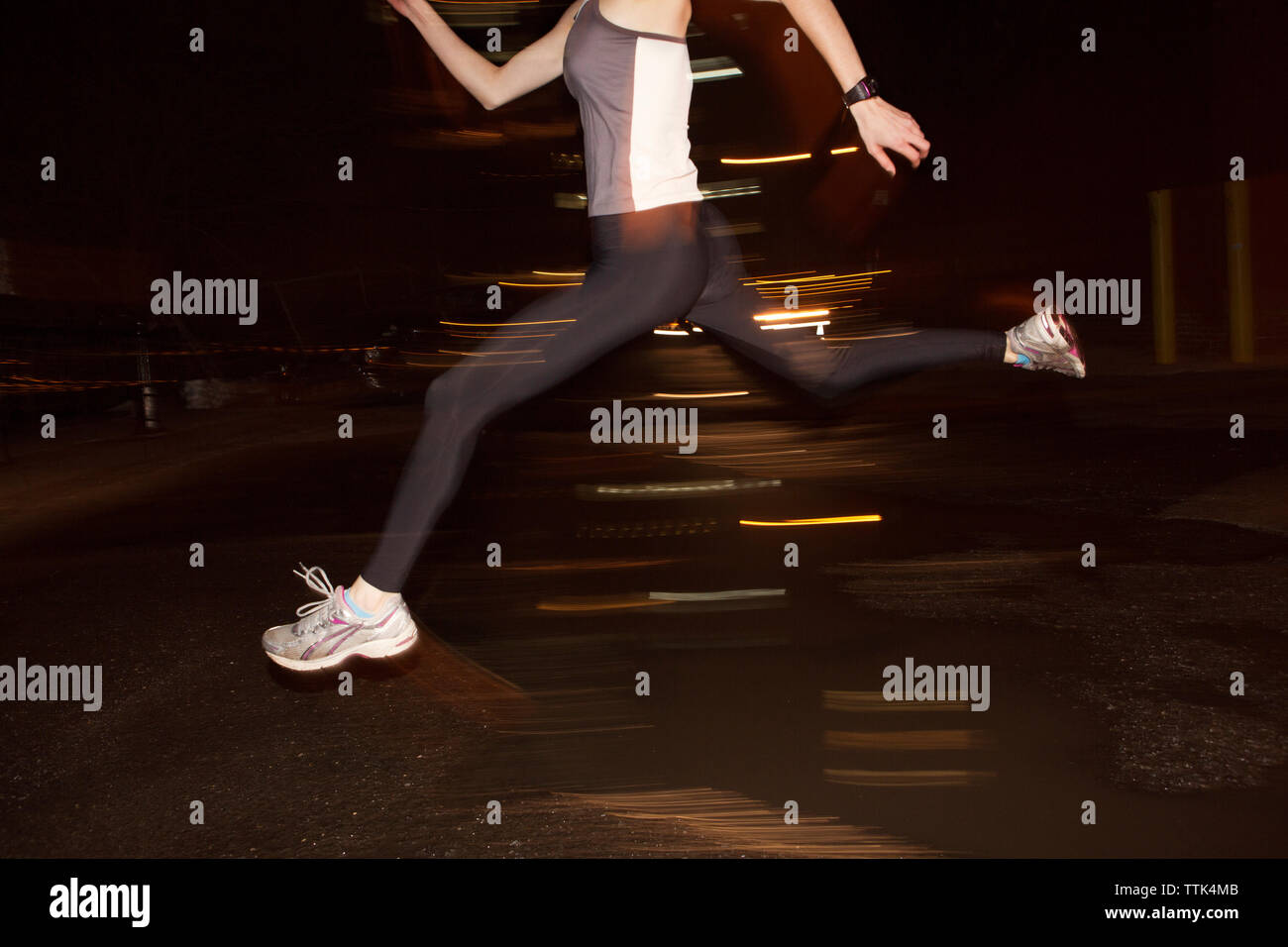 Woman jumping over puddle hi-res stock photography and images - Alamy