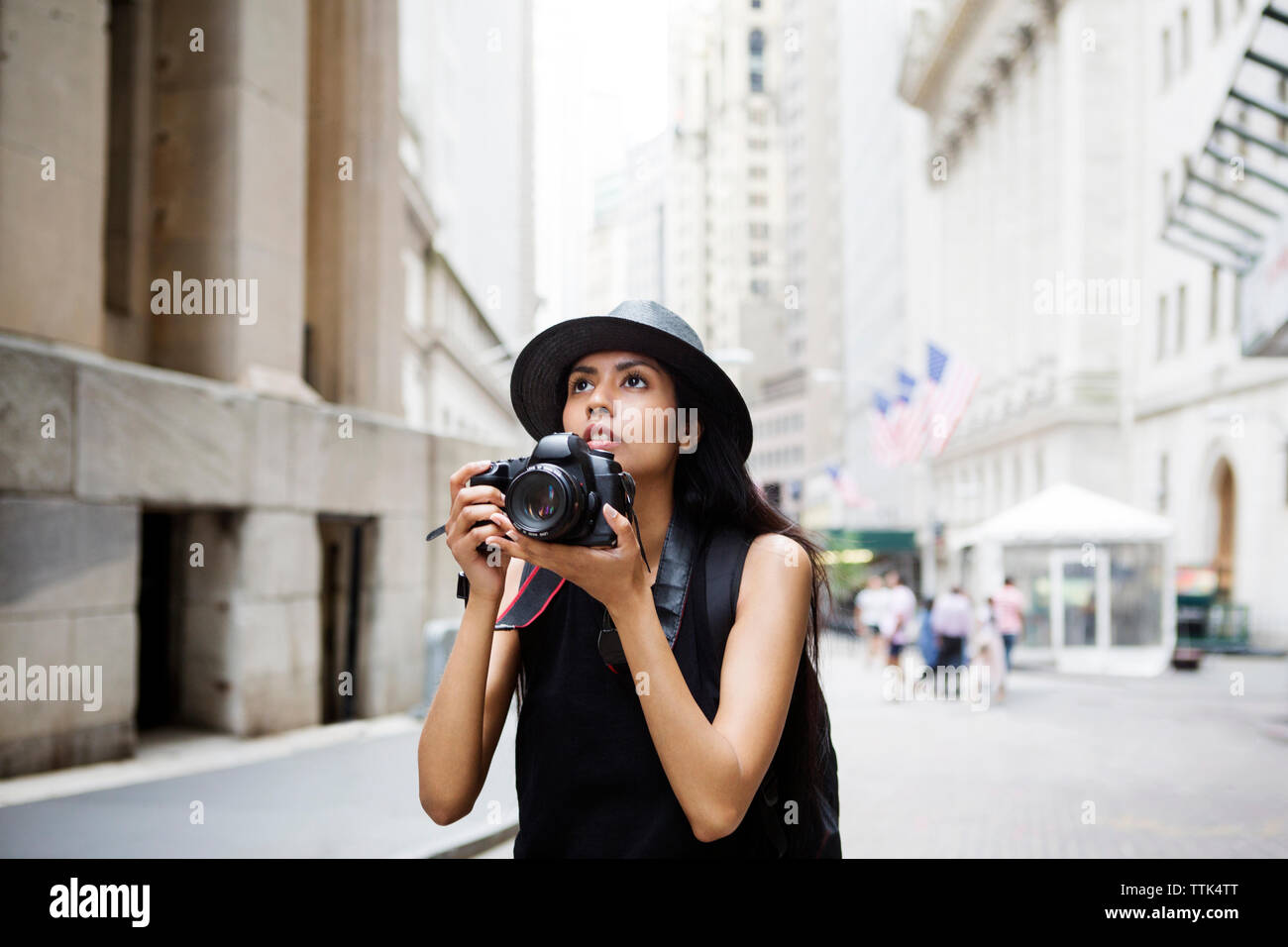 Woman standing on street photographing hi-res stock photography and ...