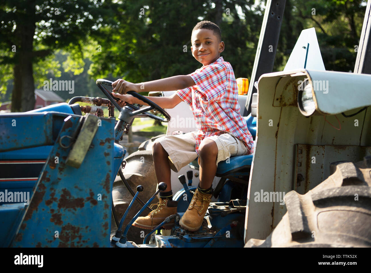 Boy on old tractor hi-res stock photography and images - Alamy
