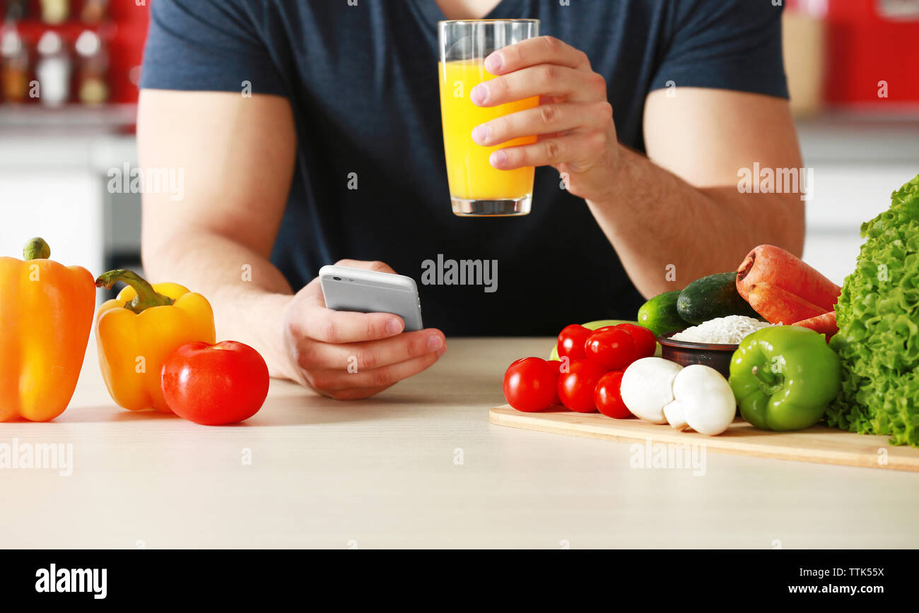 Man counting calories on table Stock Photo - Alamy