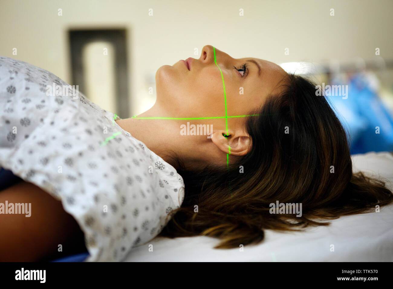 Side view of woman lying on examination table in hospital Stock Photo ...