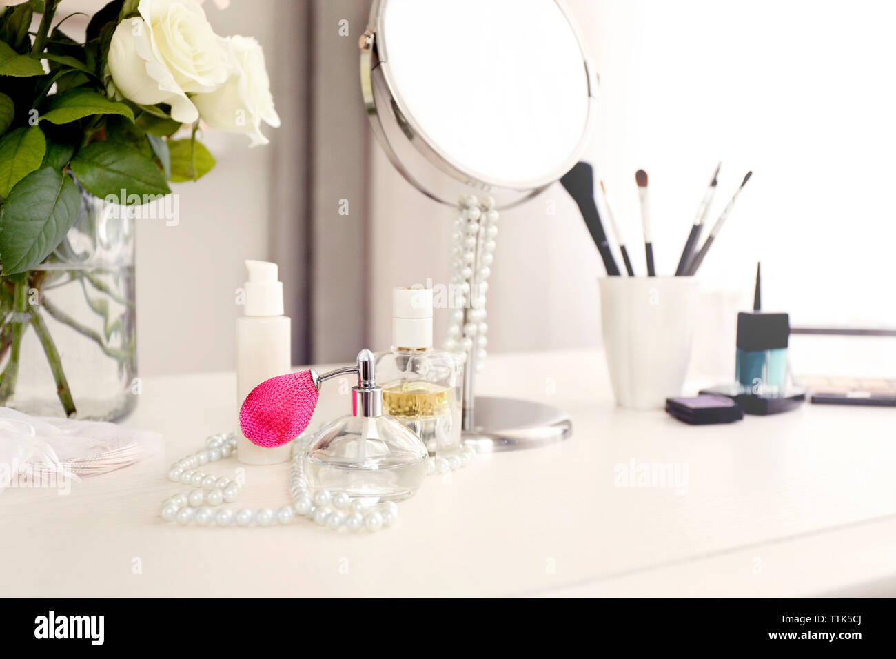 Perfume on light dressing table Stock Photo - Alamy