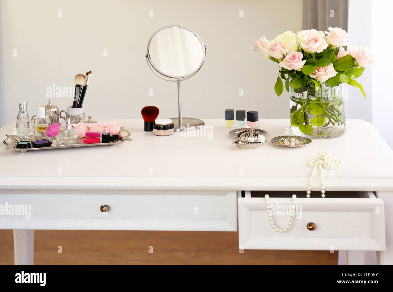 Dressing table with cosmetics in room Stock Photo - Alamy