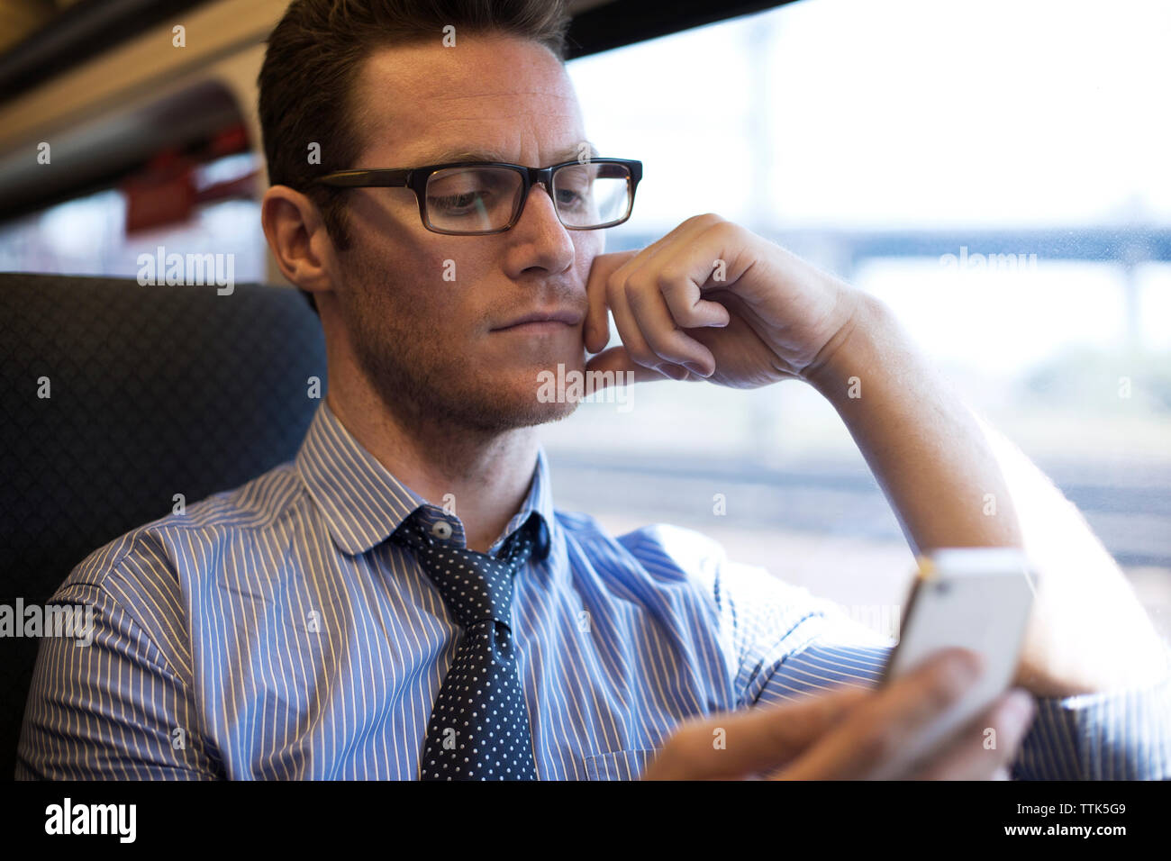 Man looking at his phone on train hi-res stock photography and images ...