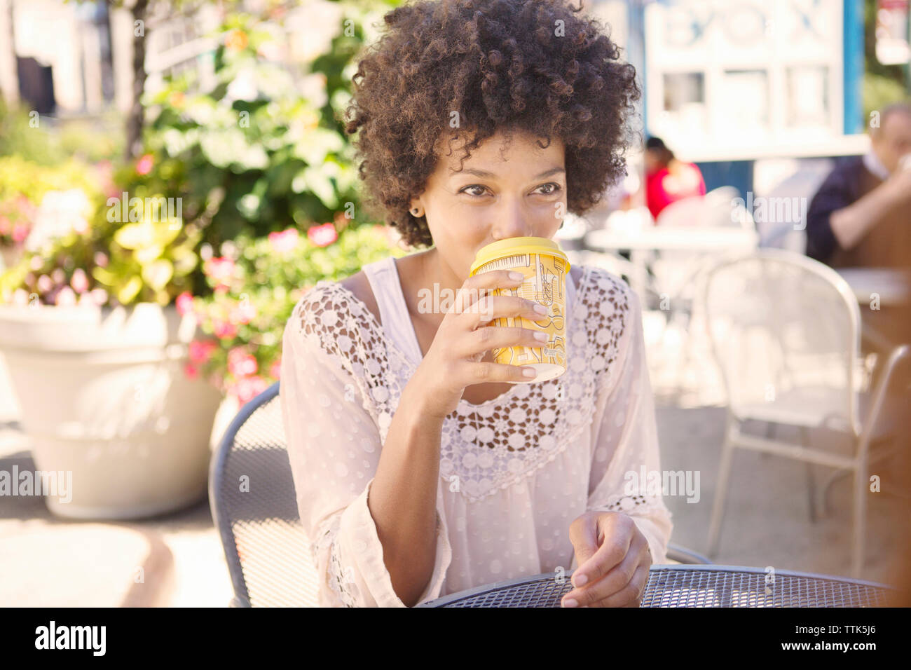 Woman sitting drinking coffee hi-res stock photography and images - Alamy
