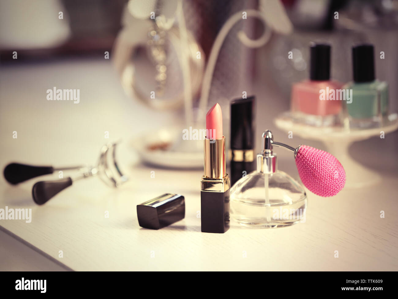 Lipstick with perfume bottle on light dressing table Stock Photo - Alamy