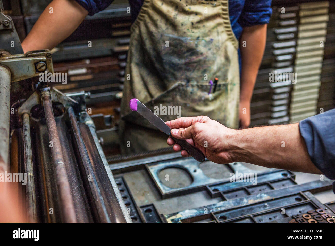 worker holding ink knife at workshop Stock Photo - Alamy