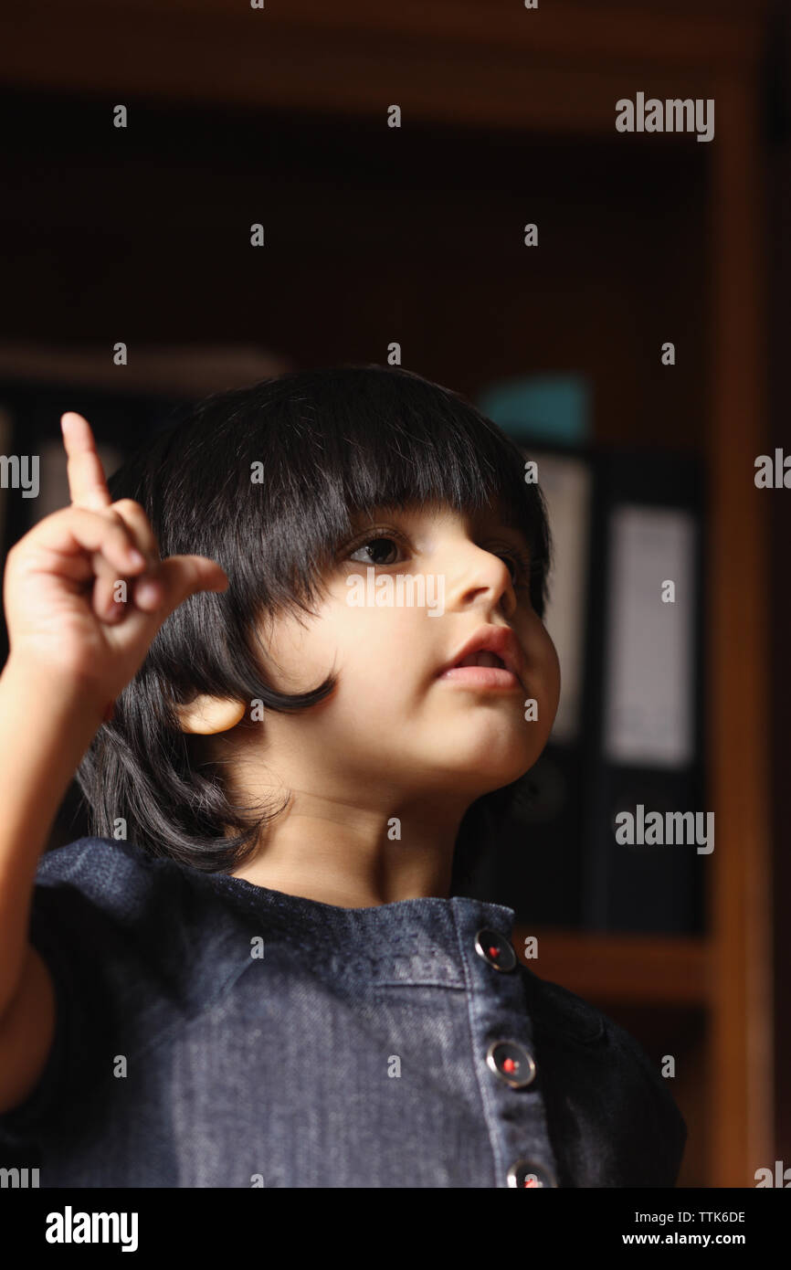 Girl pointing upward Stock Photo - Alamy
