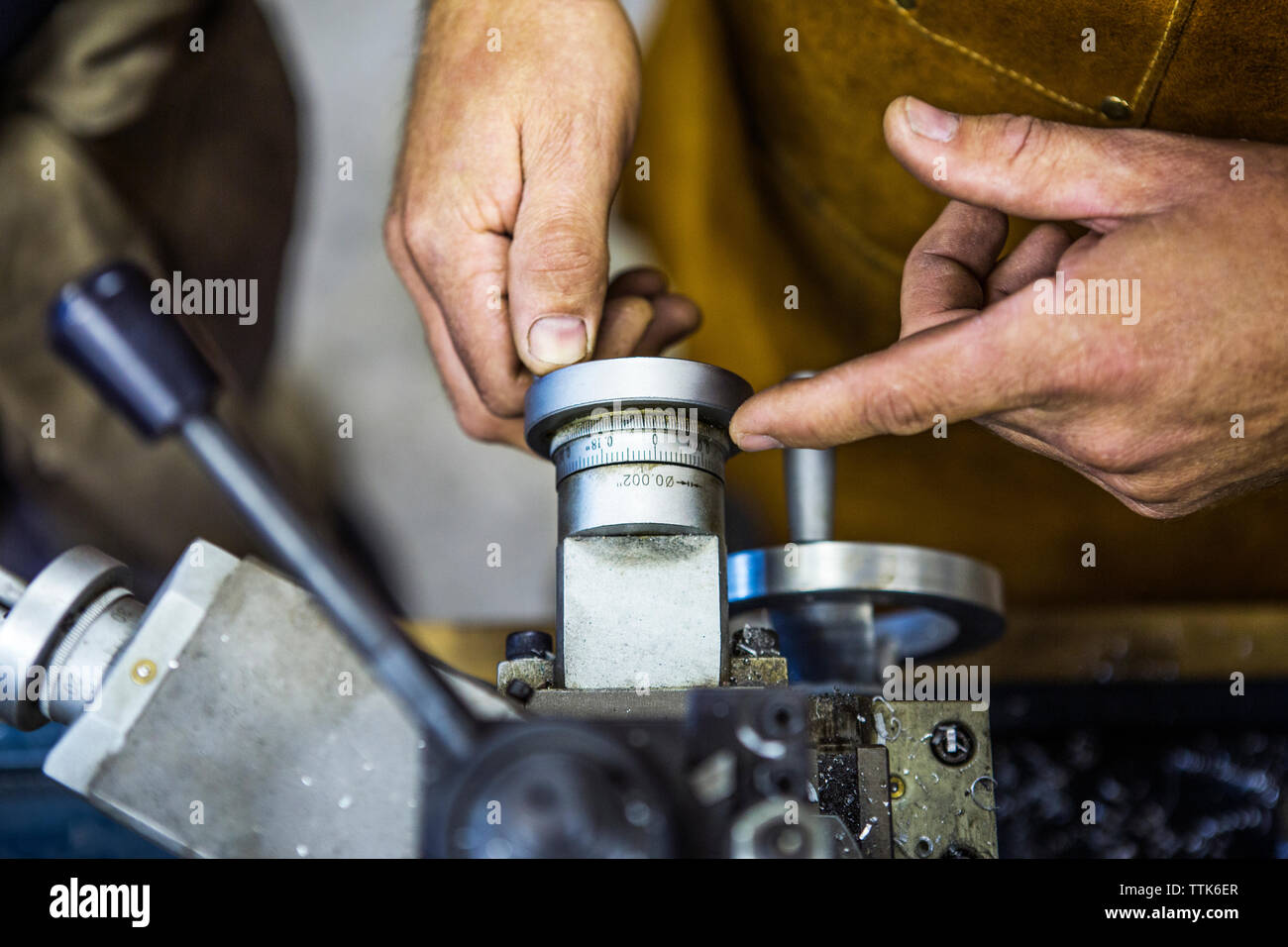Overhead view of mechanic adjusting machinery in auto repair shop Stock ...