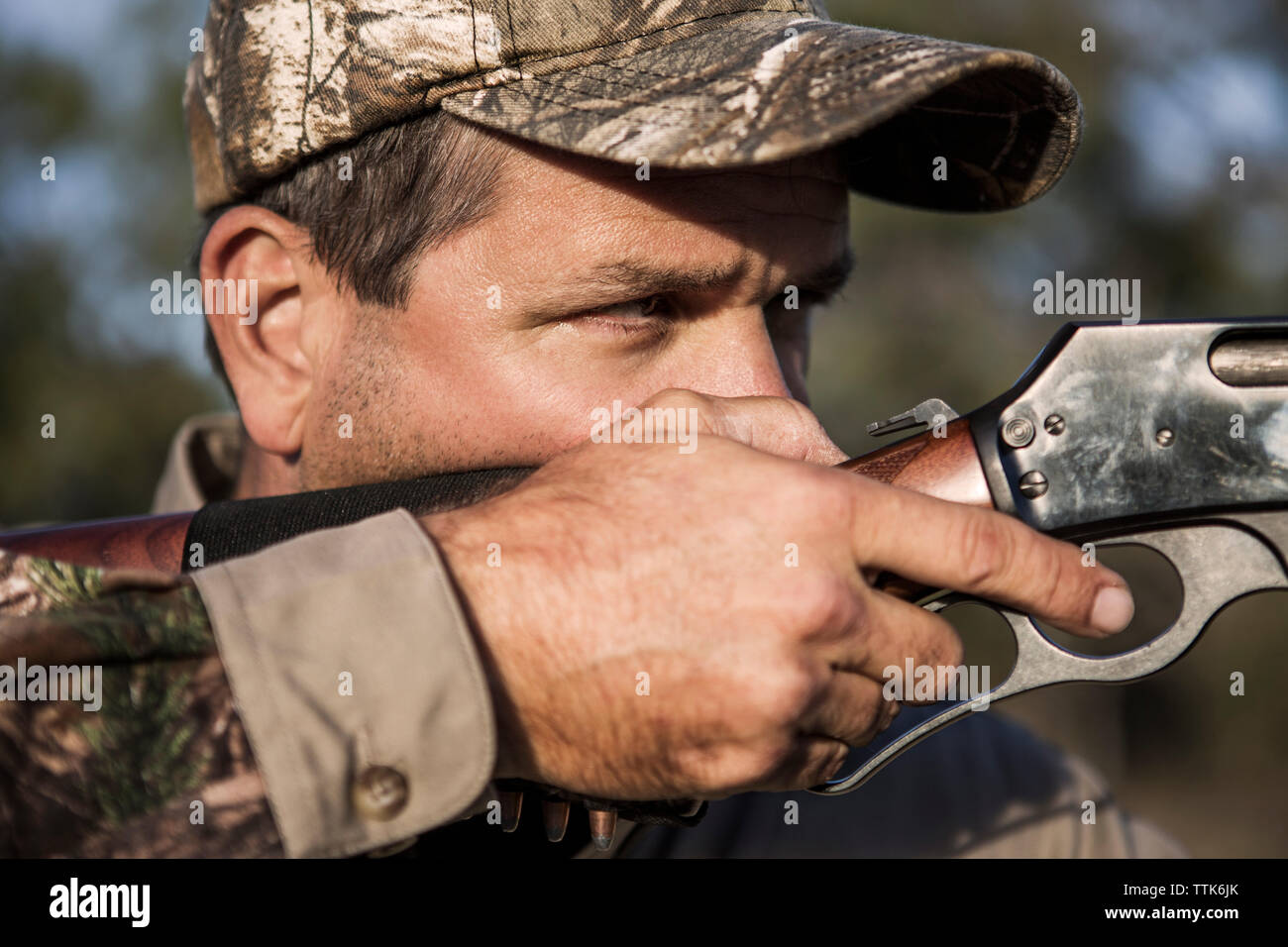 Close-up of hunter aiming with rifle Stock Photo - Alamy