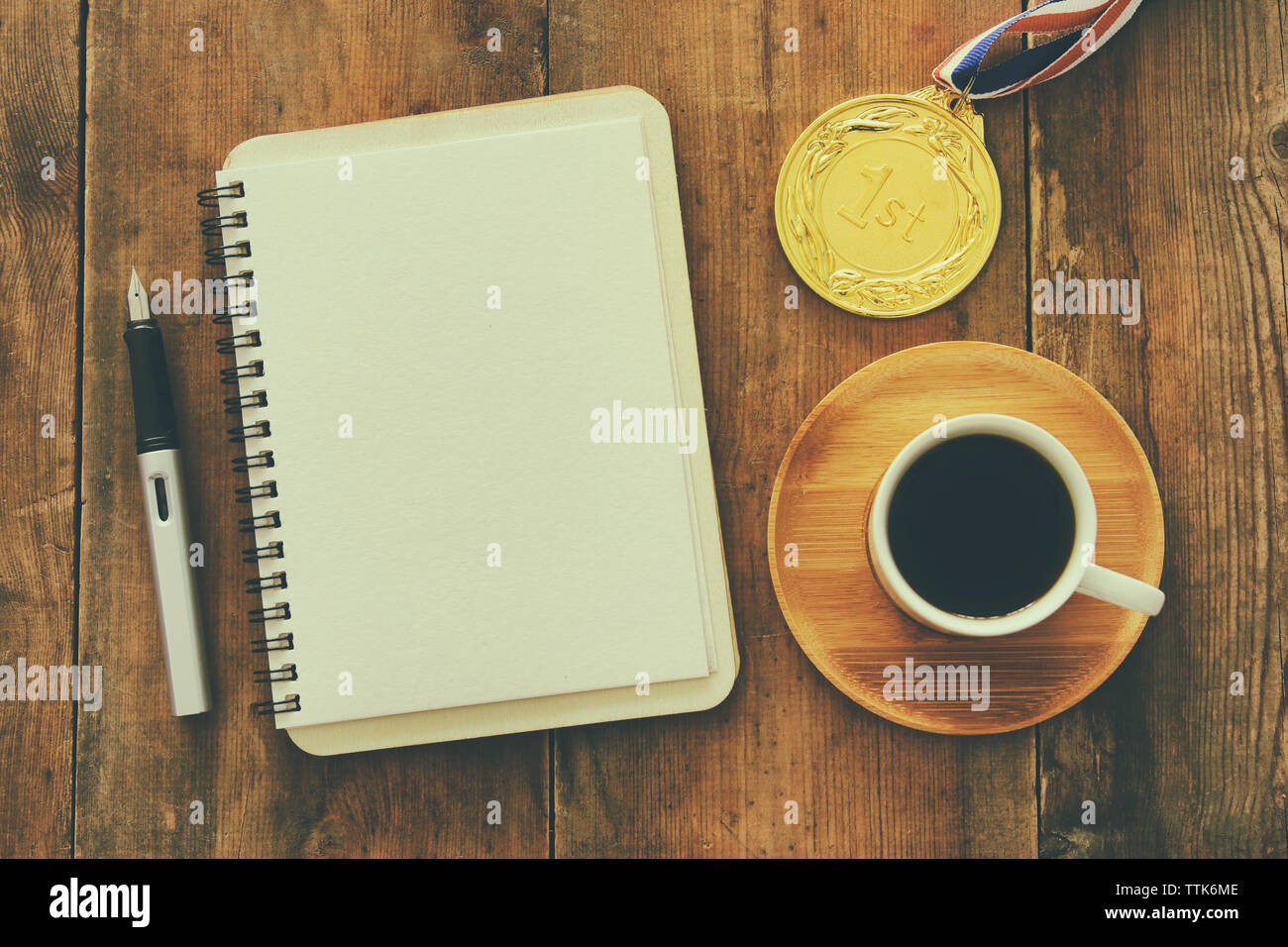 Open notebook with empty pages and other office supplies over wooden ...