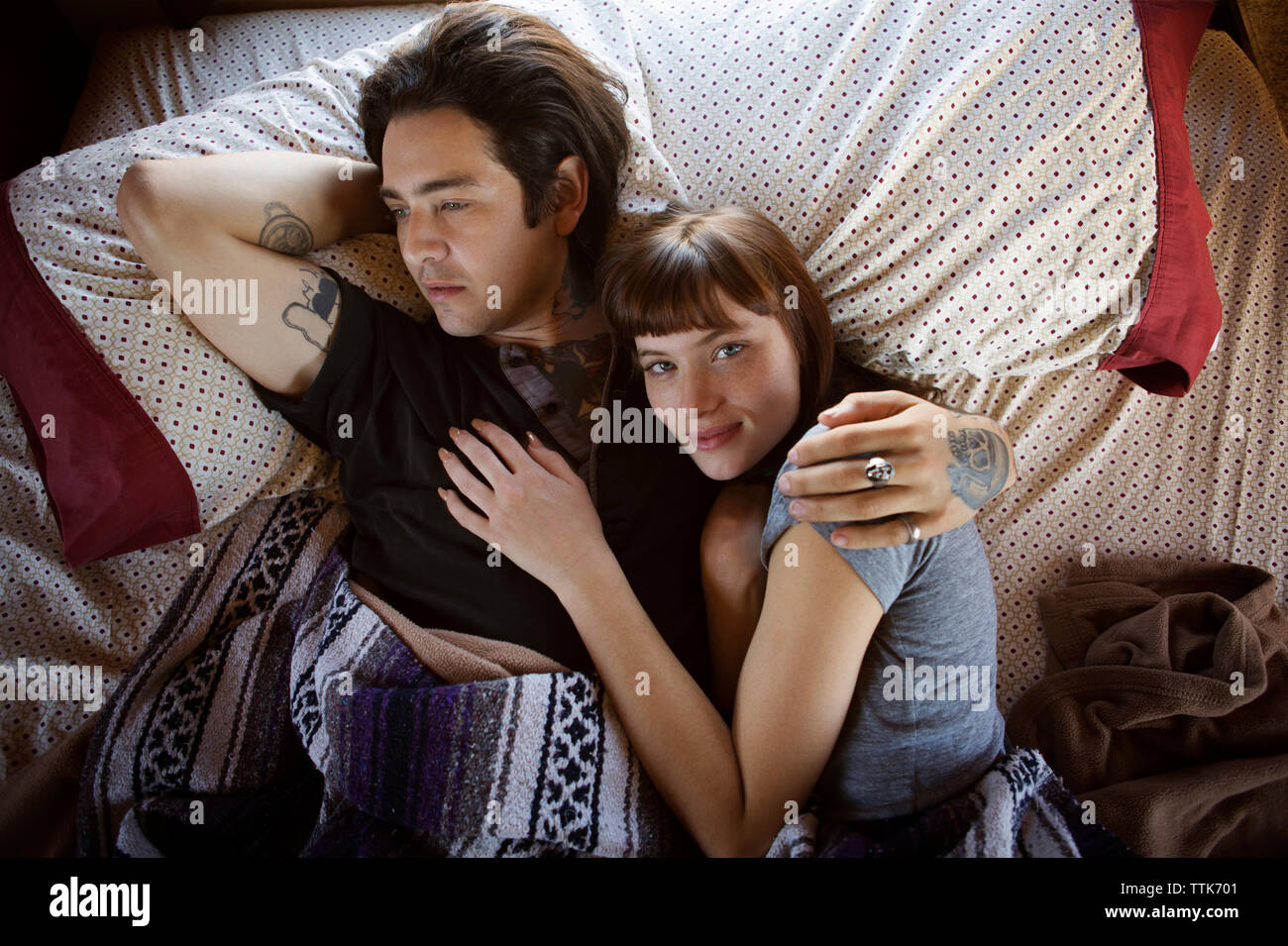 Couple relaxing on bed in camper van Stock Photo - Alamy