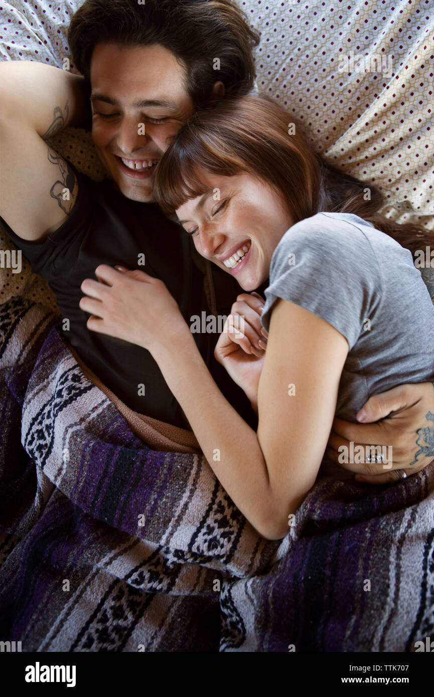 Cheerful couple relaxing on bed in camper van Stock Photo - Alamy