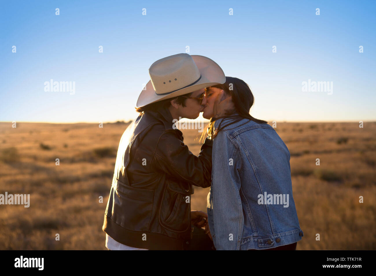 Young couple kissing on grass hi-res stock photography and images - Alamy