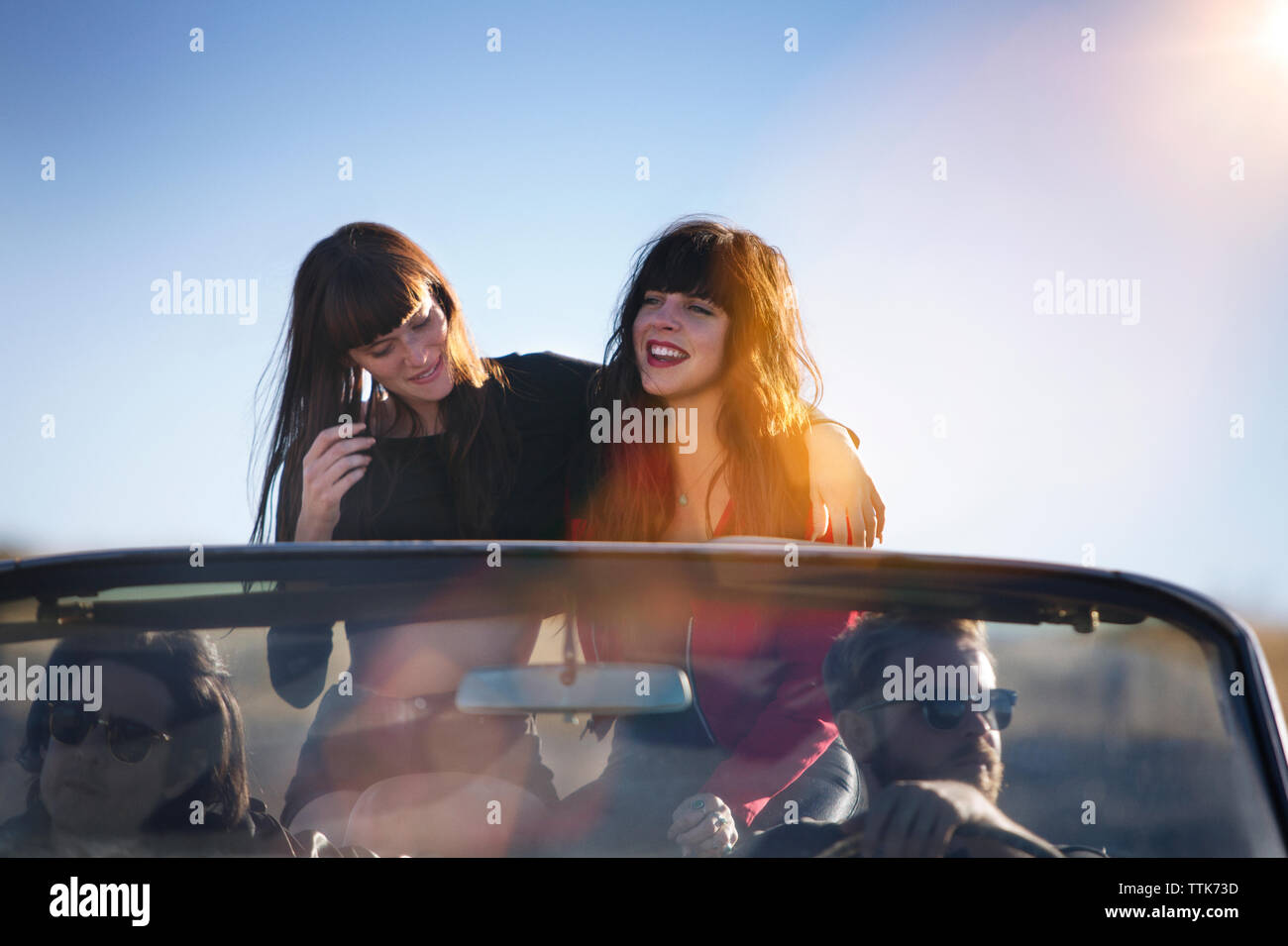 Four friends traveling in convertible hi-res stock photography and ...