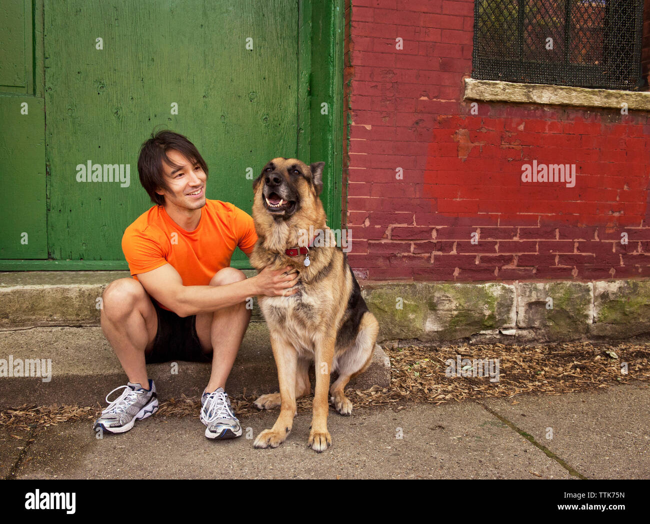 Man sitting with German shepherd Stock Photo - Alamy