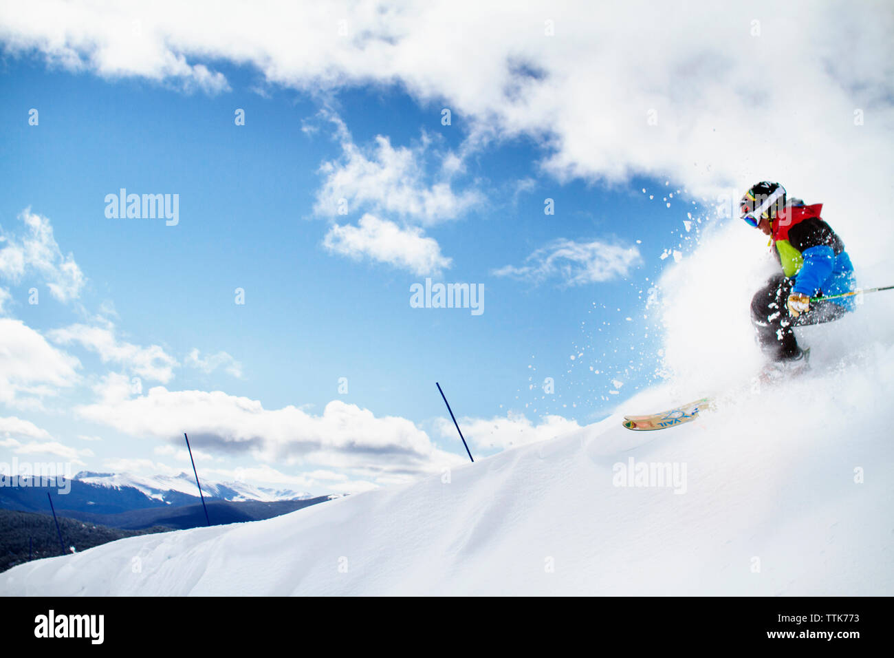Man skiing on snow against cloudy sky Stock Photo - Alamy