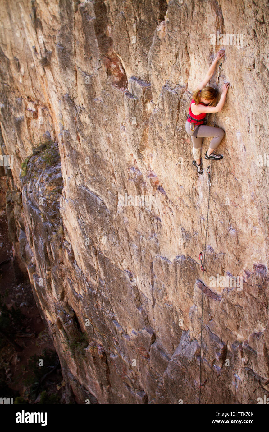 Side view of woman climbing mountain Stock Photo - Alamy