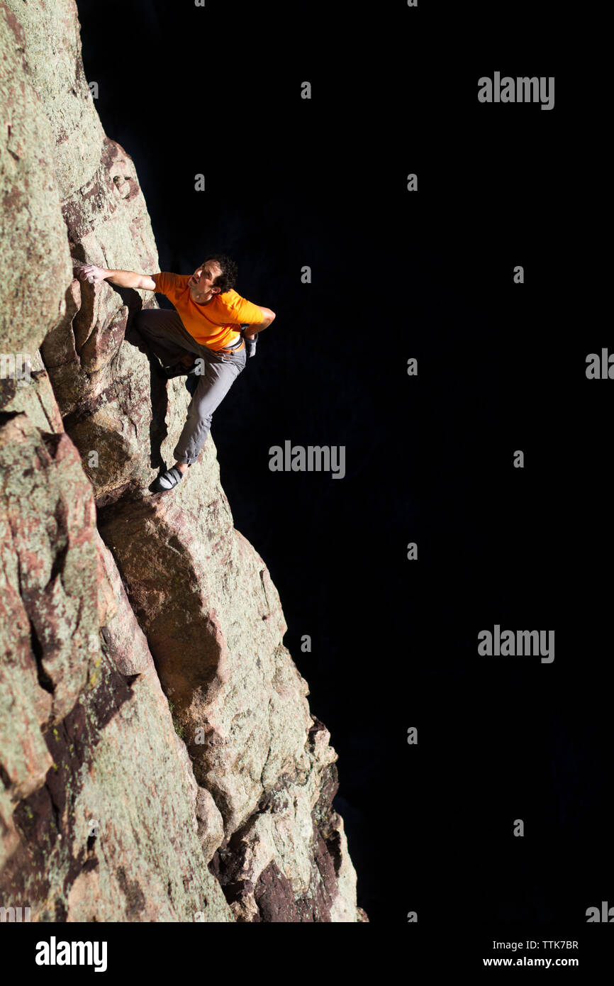 High angle view of man climbing rock mountain Stock Photo - Alamy