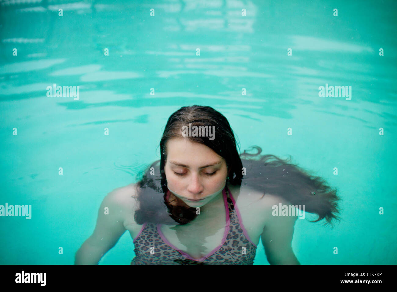 Woman standing with eyes closed in swimming pool Stock Photo - Alamy