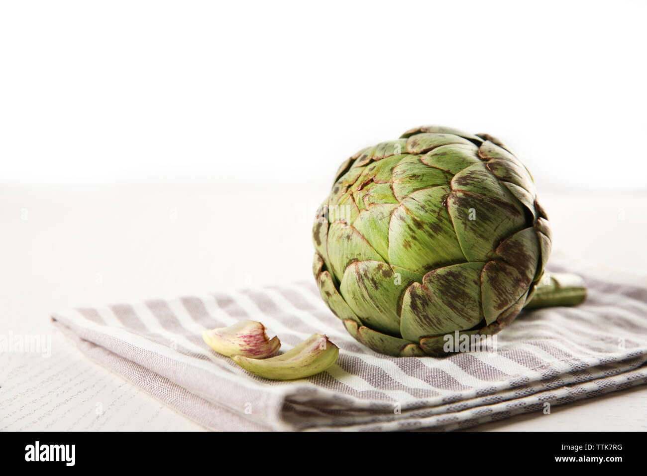 Raw artichoke on napkin Stock Photo - Alamy