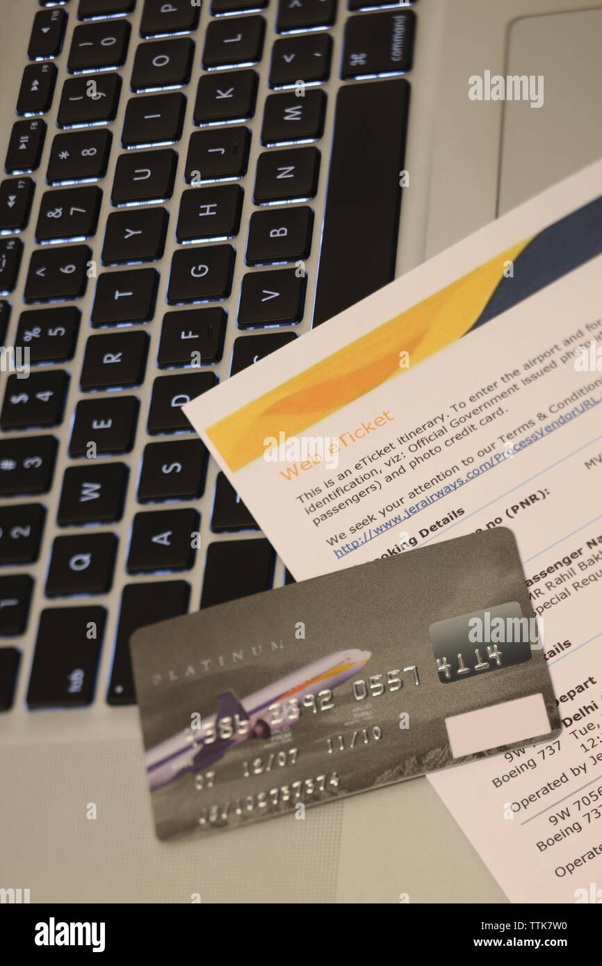 Air ticket and a credit card on a laptop Stock Photo - Alamy
