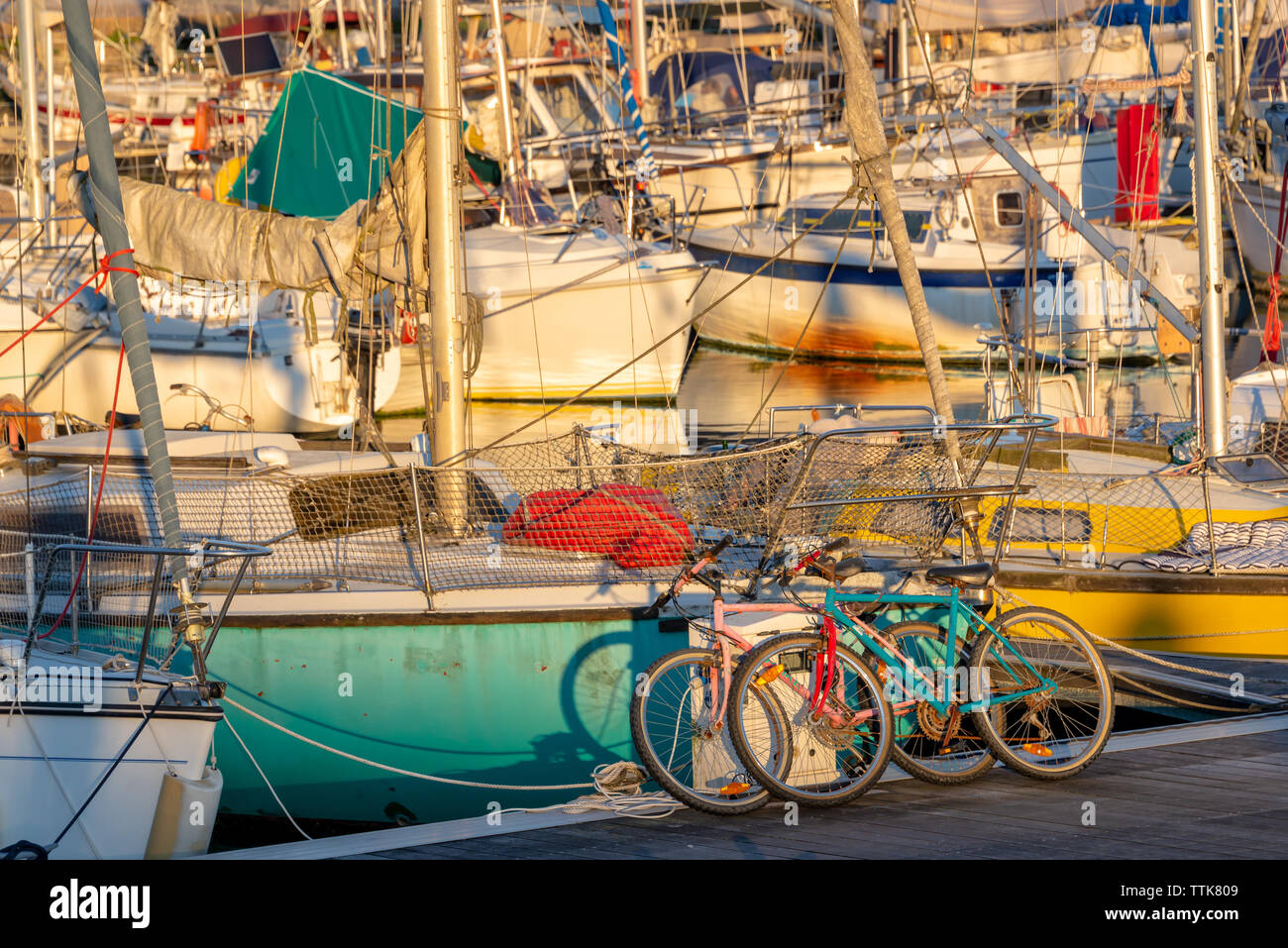 Colorful bicycles and sailing boats at sunset in the harbor of La ...