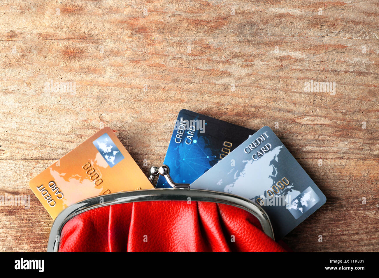 Credit cards in purse on wooden background Stock Photo - Alamy
