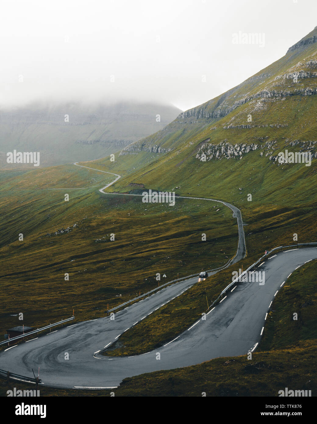 Scenic view of winding road during foggy weather Stock Photo - Alamy