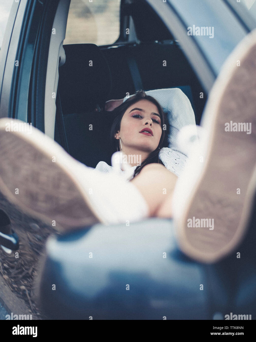 Portrait of confident woman relaxing in car seen through window Stock ...