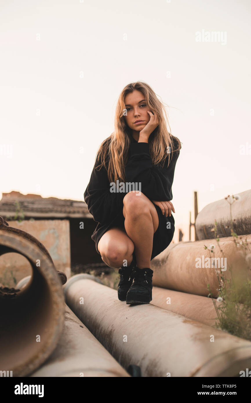 Portrait young woman crouching on hi-res stock photography and images ...