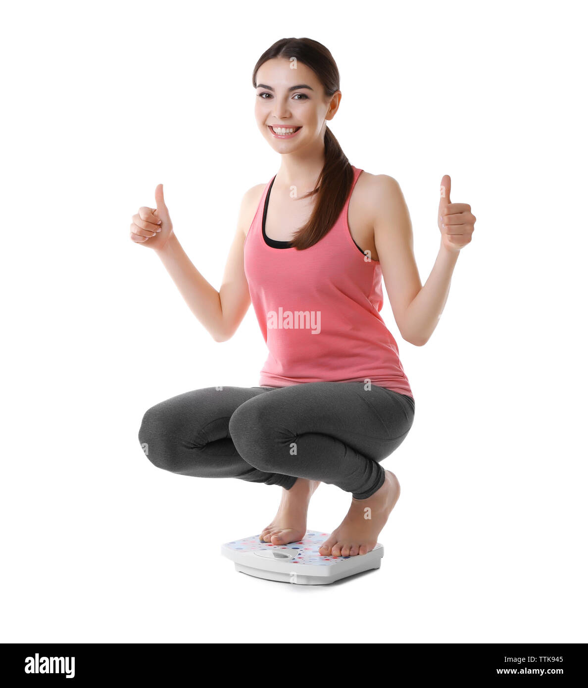 Woman standing on scale isolated on white Stock Photo - Alamy