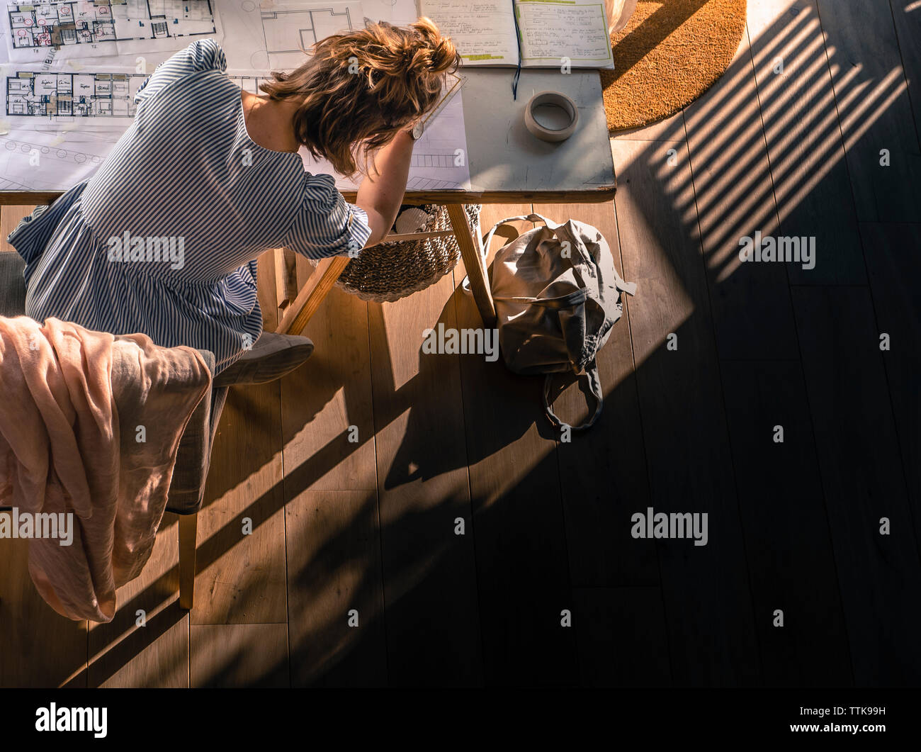 Young woman drawing architect plans from above Stock Photo - Alamy