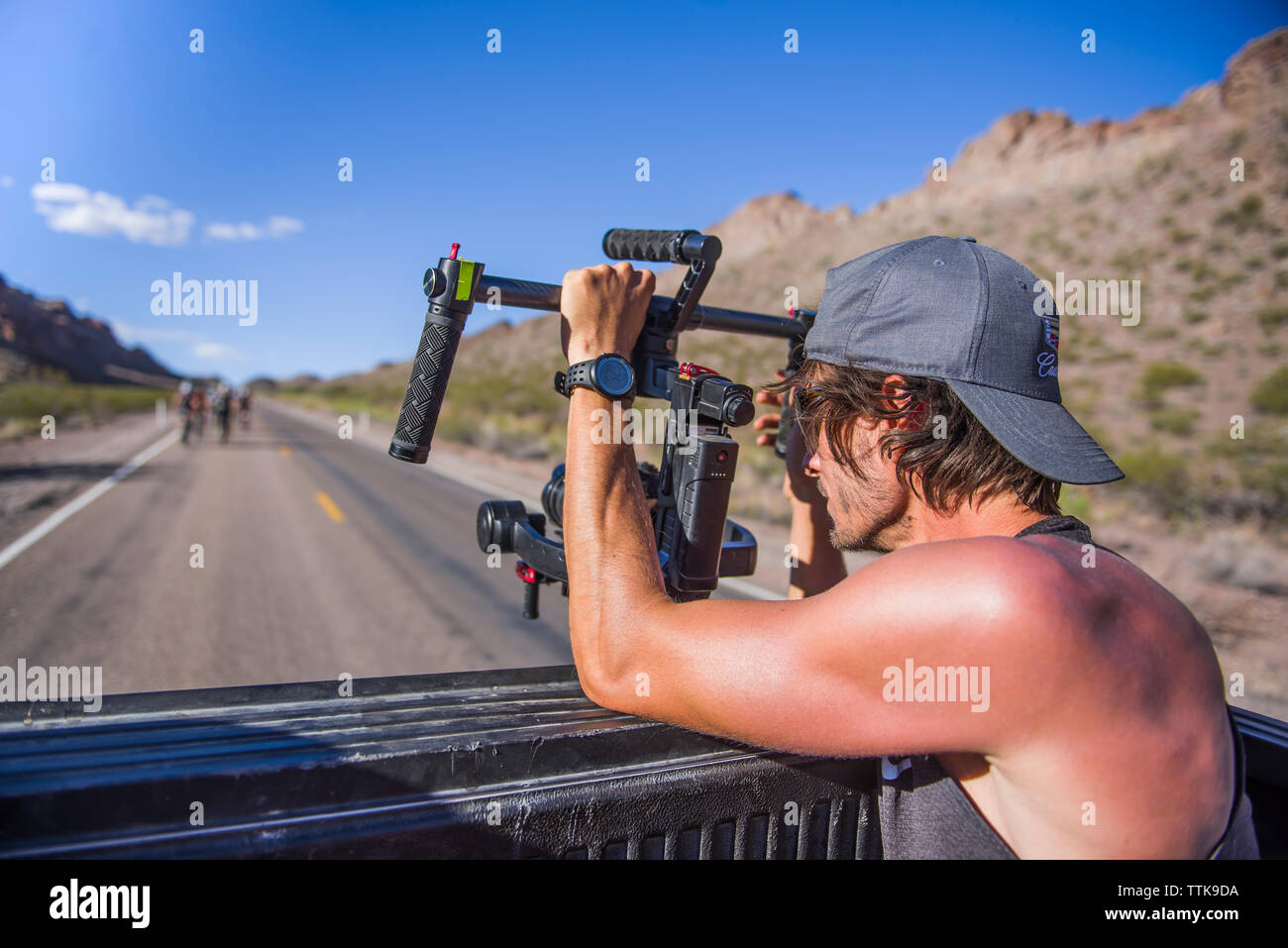Videographer filming with Gimbal stabilizer from back of truck Stock ...