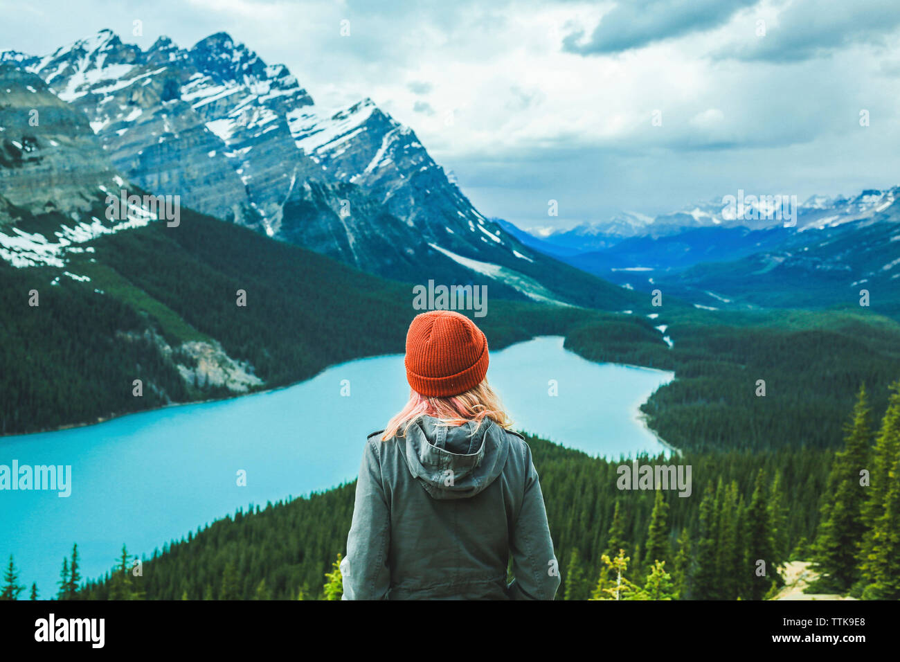 Rear view of woman looking at view while standing at Banff National ...