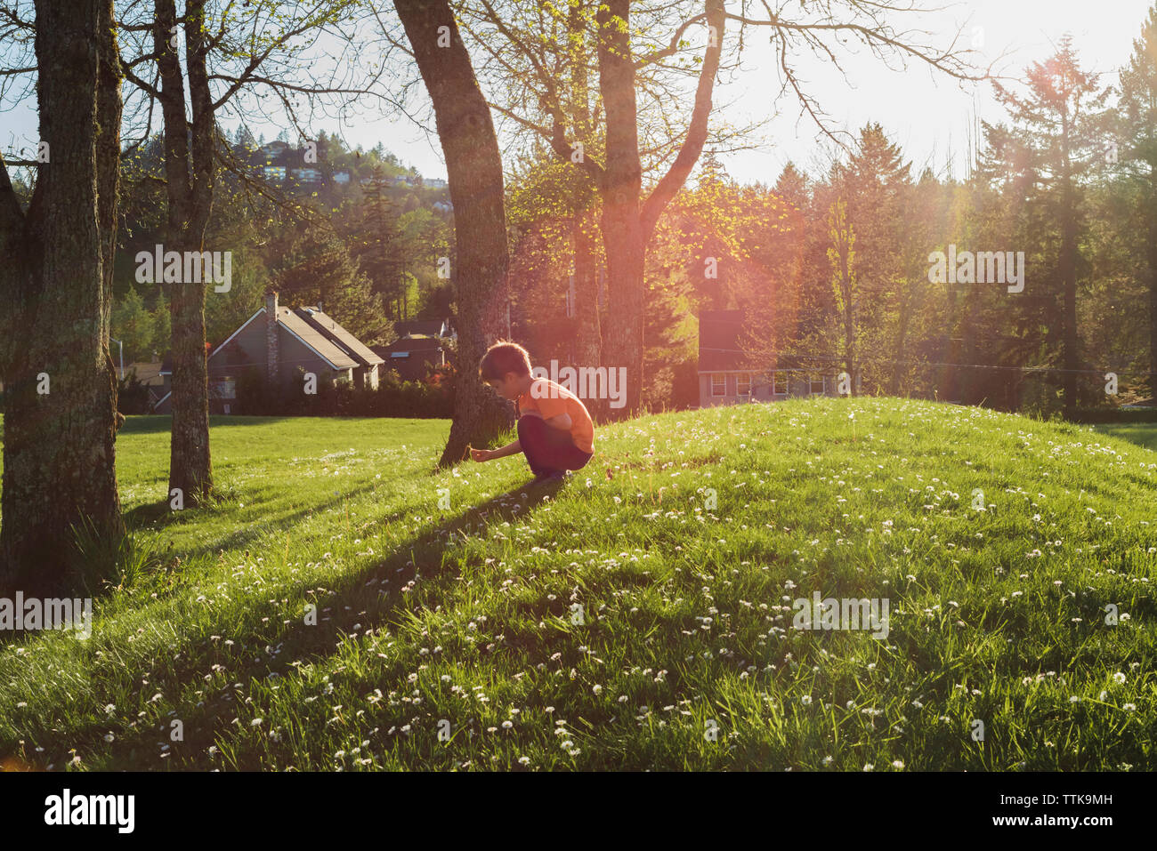 Male crouching on grass hi-res stock photography and images - Alamy