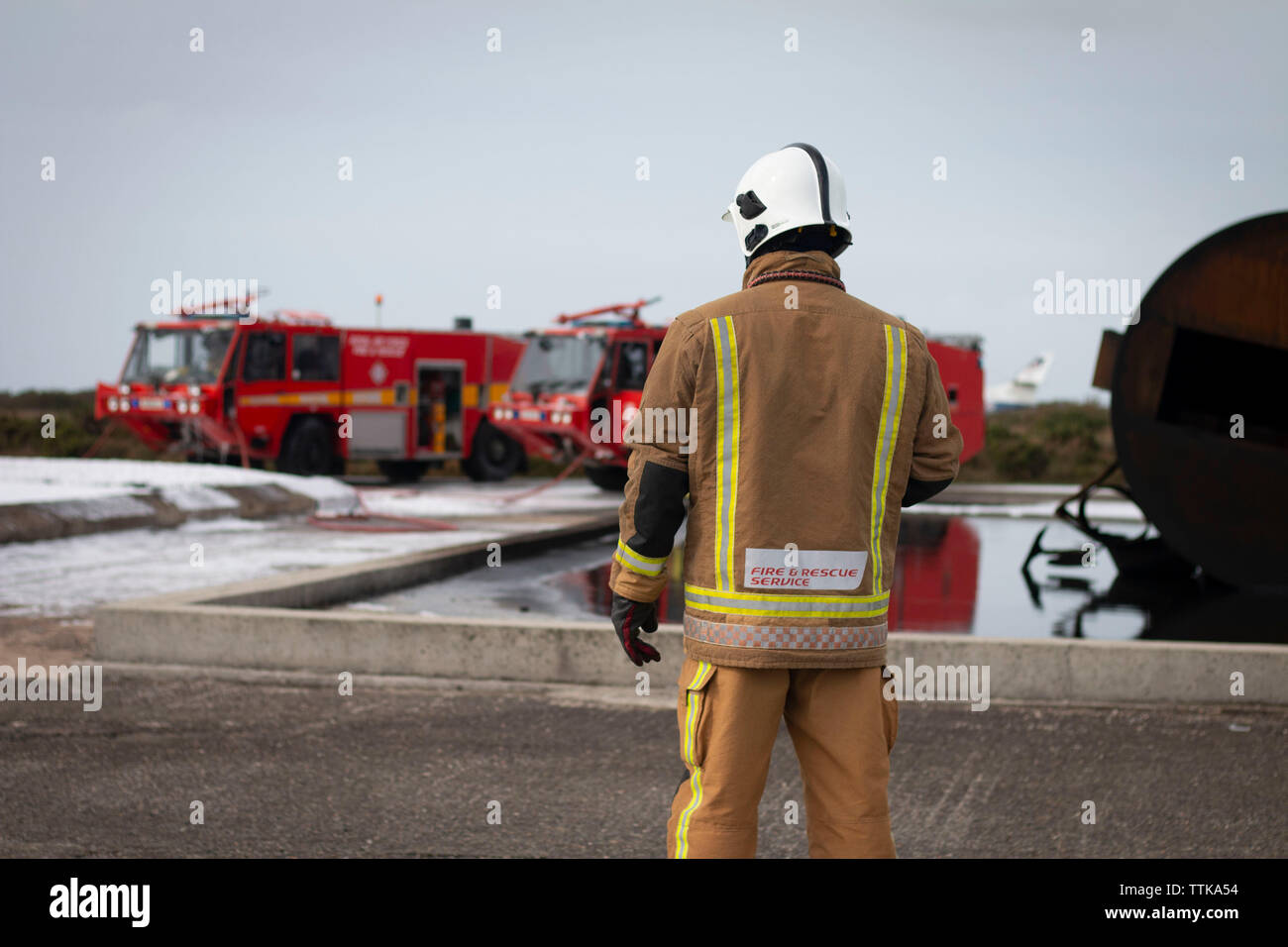 Fireman overseeing workers Stock Photo - Alamy