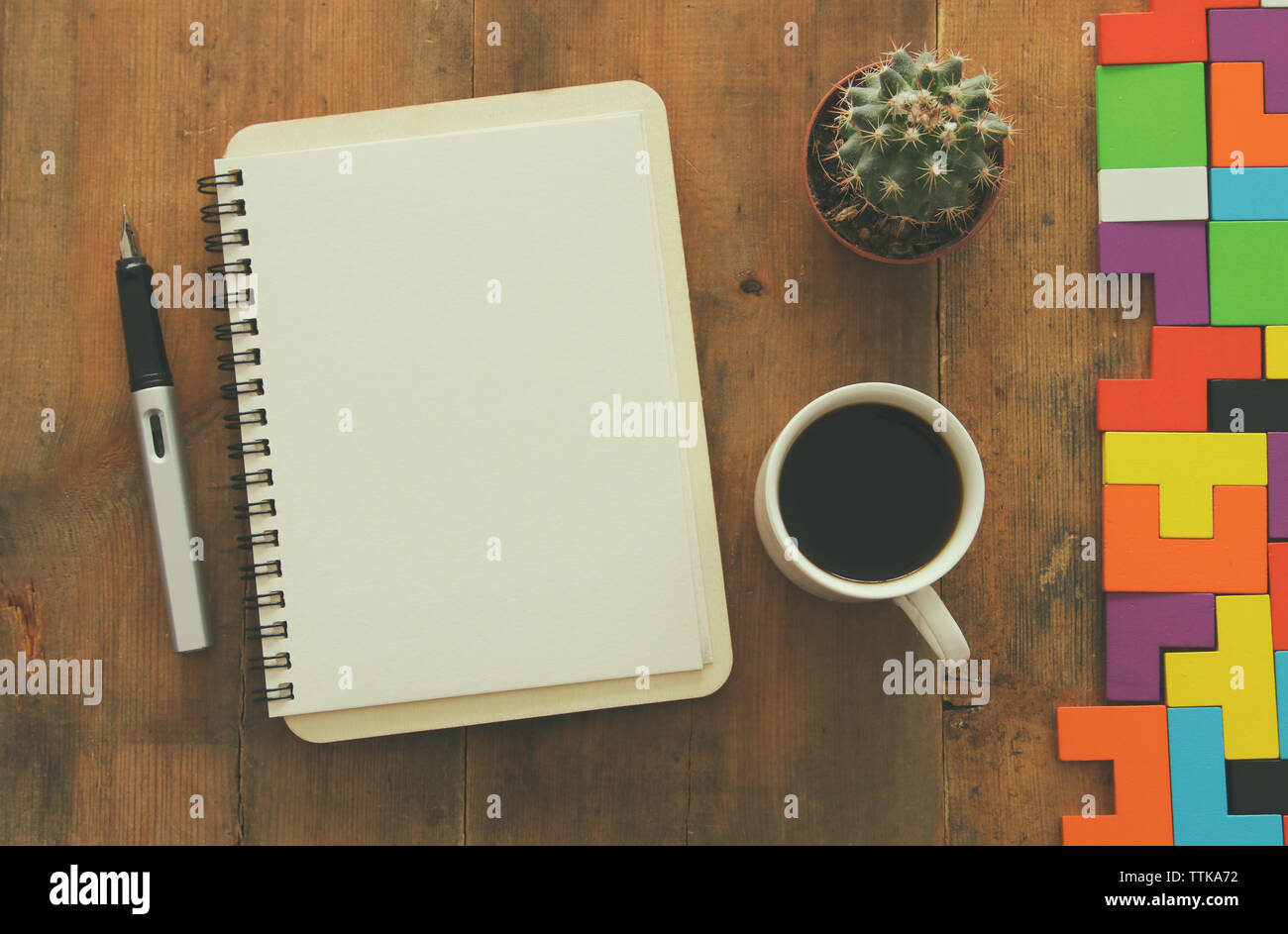 Open notebook with empty pages over wooden old office desk table. Top ...