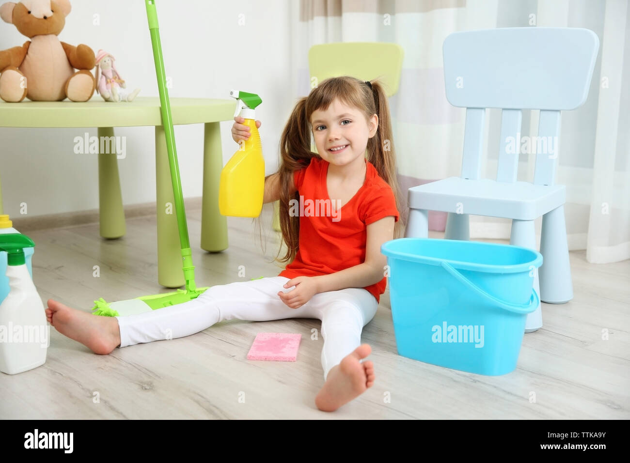 Cute little girl cleaning her room Stock Photo - Alamy